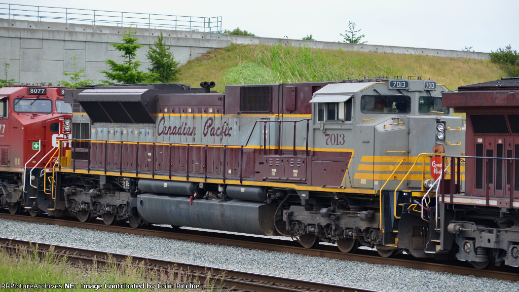 Heritage unit CP 7013, running 2nd position of 4 CP locomotives, pulling a unit stack train W/B ...